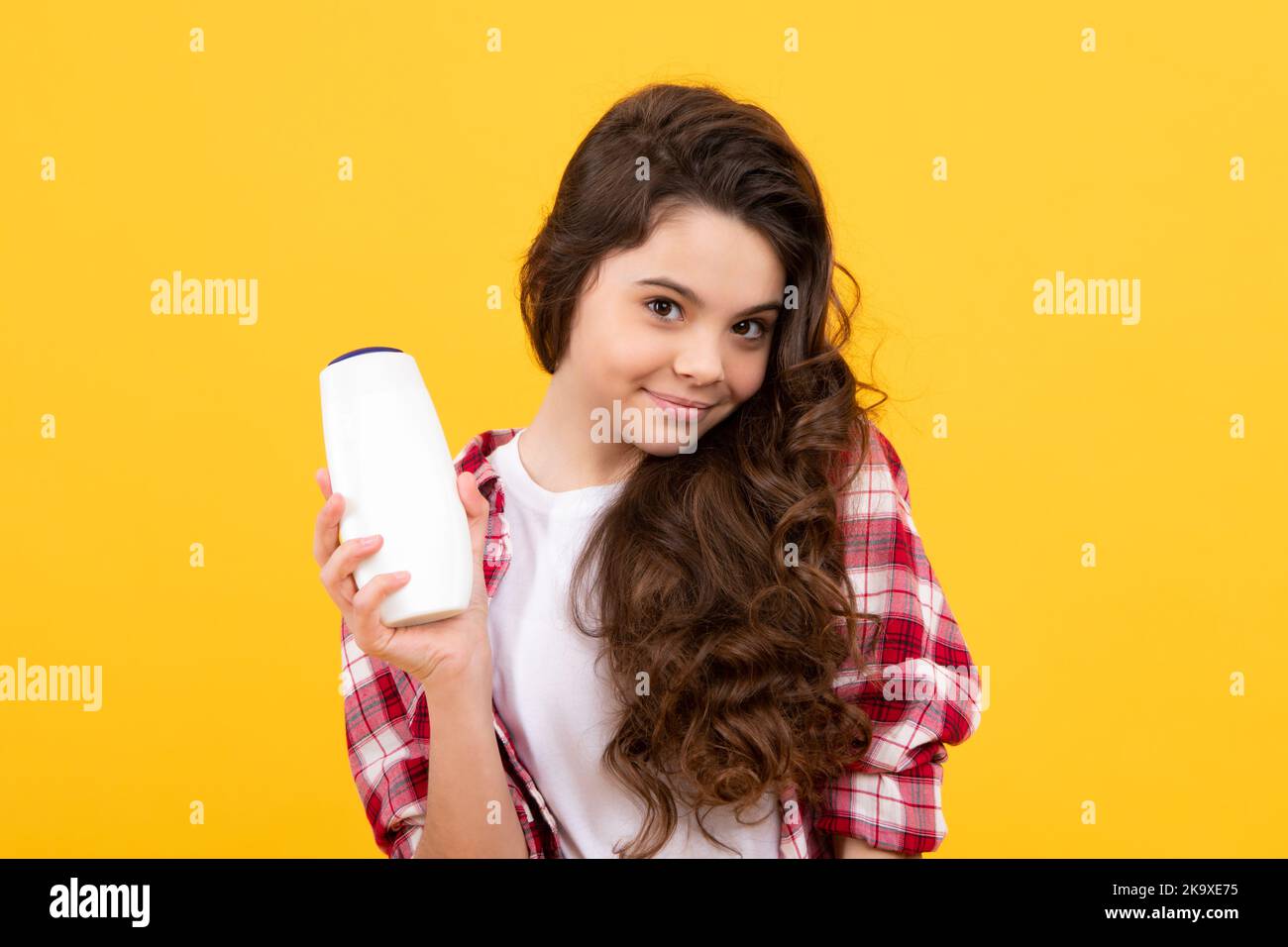Child teen girl with shampoos conditioners and shower gel. Long hair ...