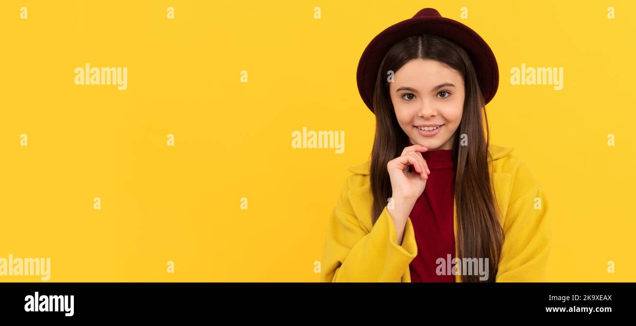 smiling kid in hat and coat on yellow background, fall. Child face ...