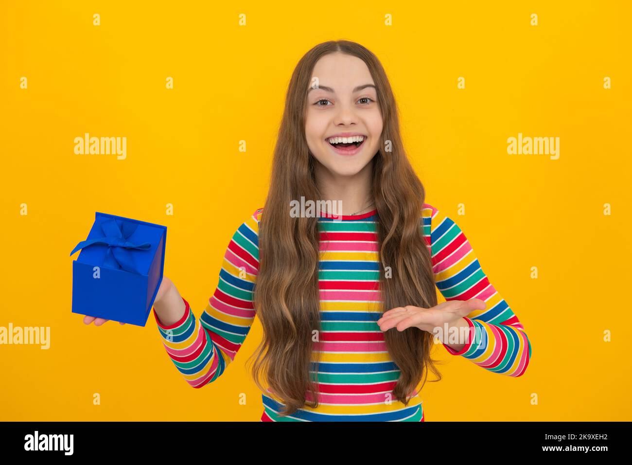 Teenager kid with present box. Teen child girl giving birthday gift ...