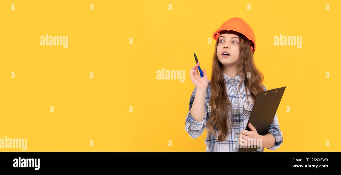 concentrated child worker wear hardhat hold clipboard. childhood ...