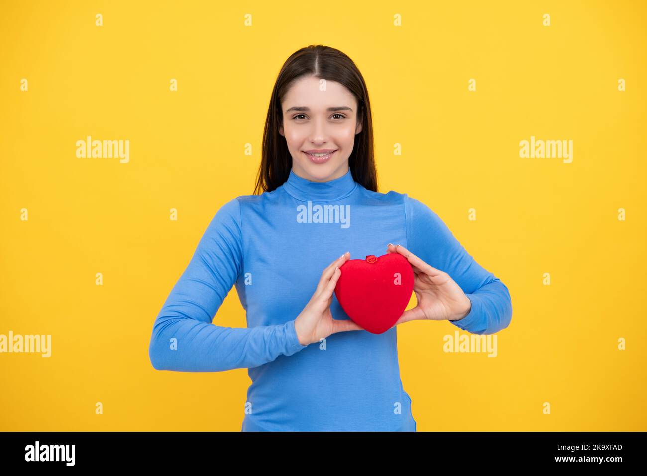 Portrait Of Lovely Sweet Cute Pretty Girl Hold Red Paper Card Heart Isolated Over Yellow