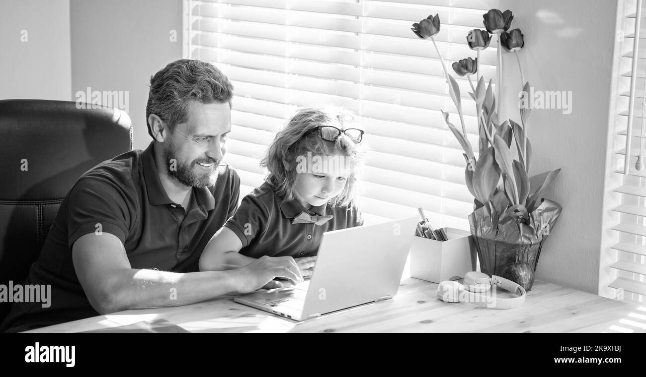 happy dad helping his school son child in glasses study with computer ...