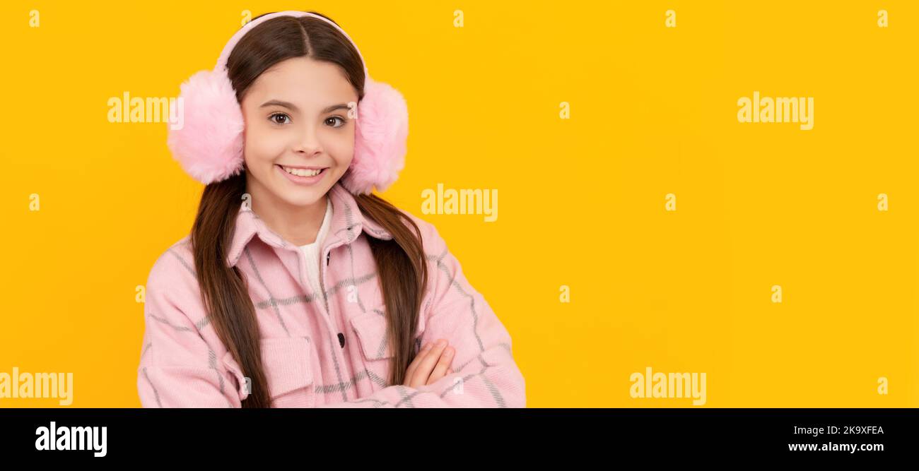 Keep your ears warm. Happy girl in overcoat wear fur earmuffs. Warm ... Keep your ears warm. Happy girl in overcoat wear fur earmuffs. Warm ...