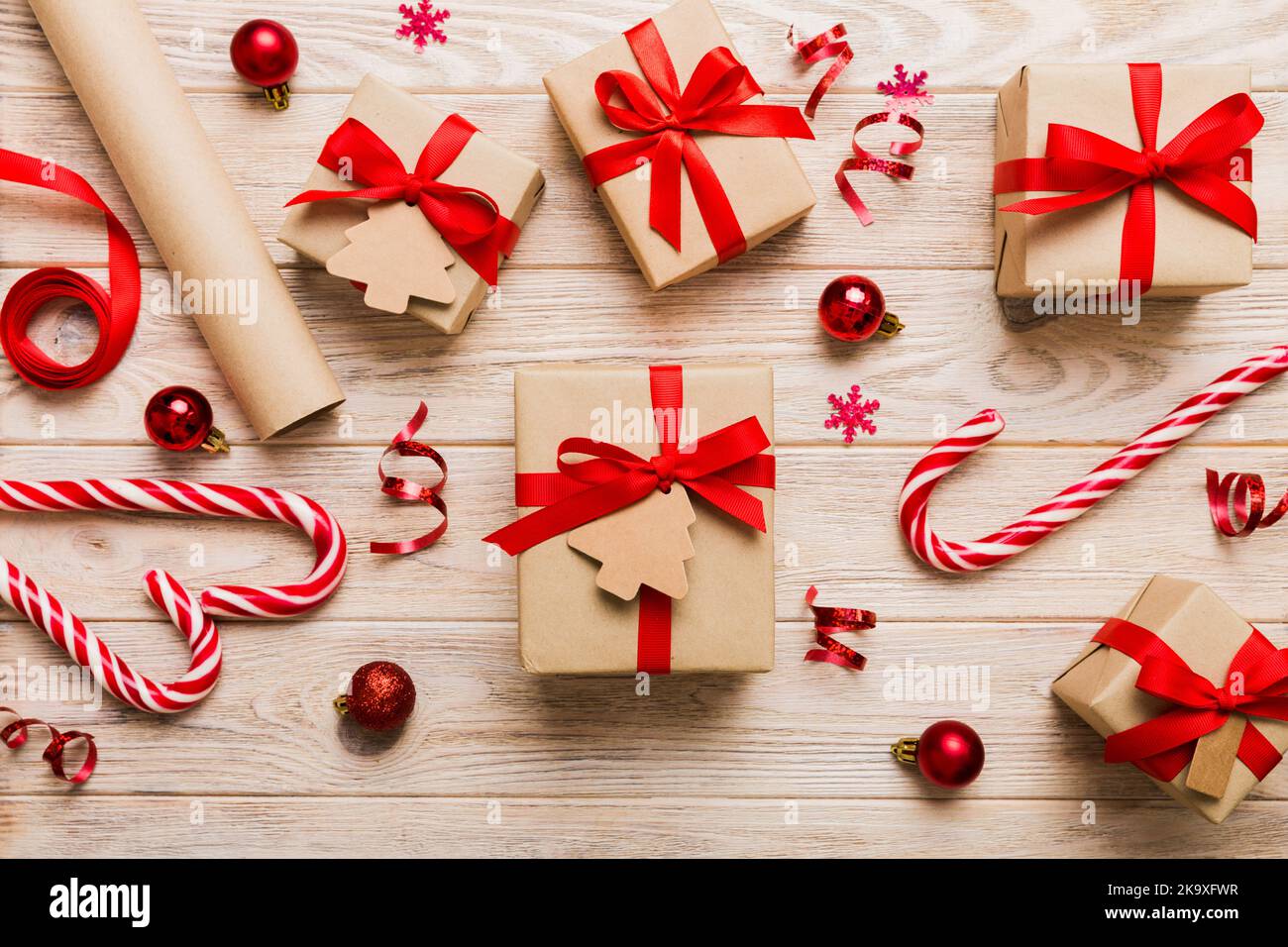 Christmas kraft gifts box with ribbon on colored background. Cozy ...