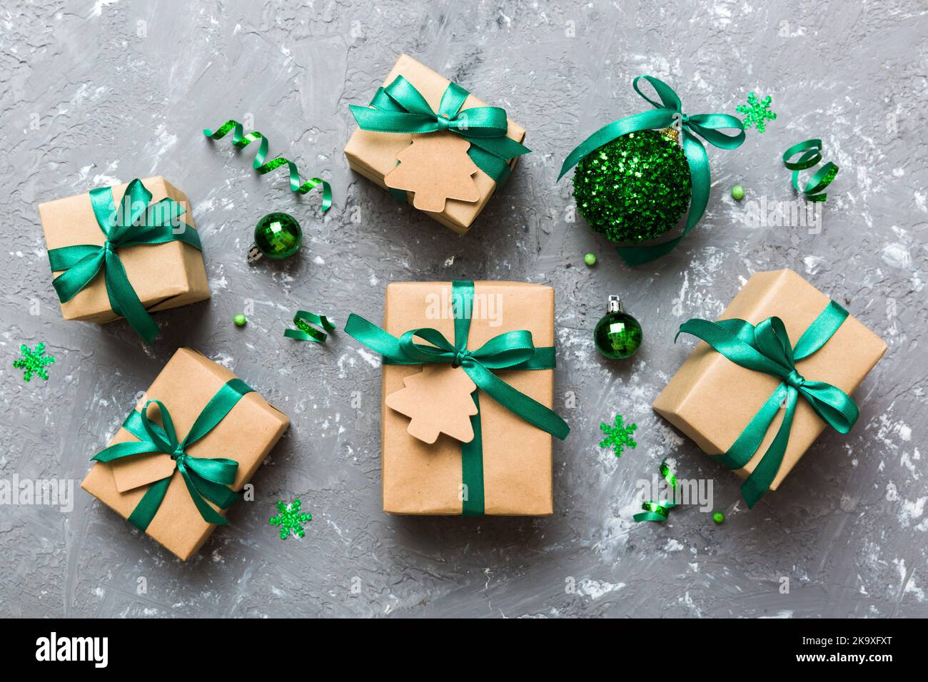 Christmas kraft gifts box with ribbon on colored background. Cozy ...