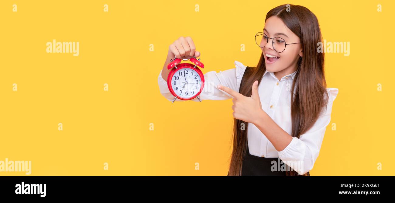 punctual teen girl checking time. happy nerd child pointing finger on ...