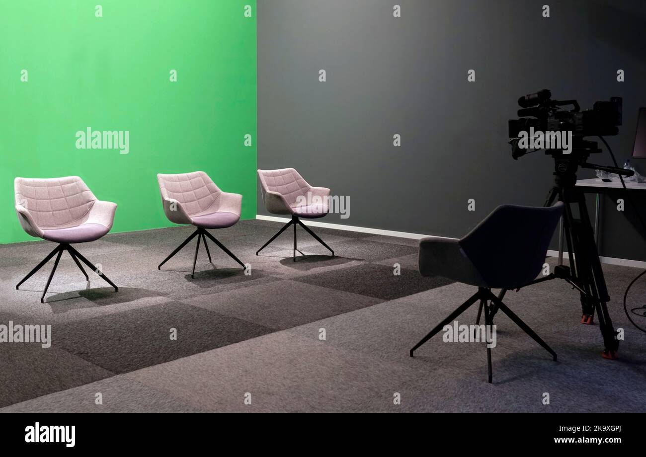 Three empty chairs in a TV studio with green screen Stock Photo - Alamy