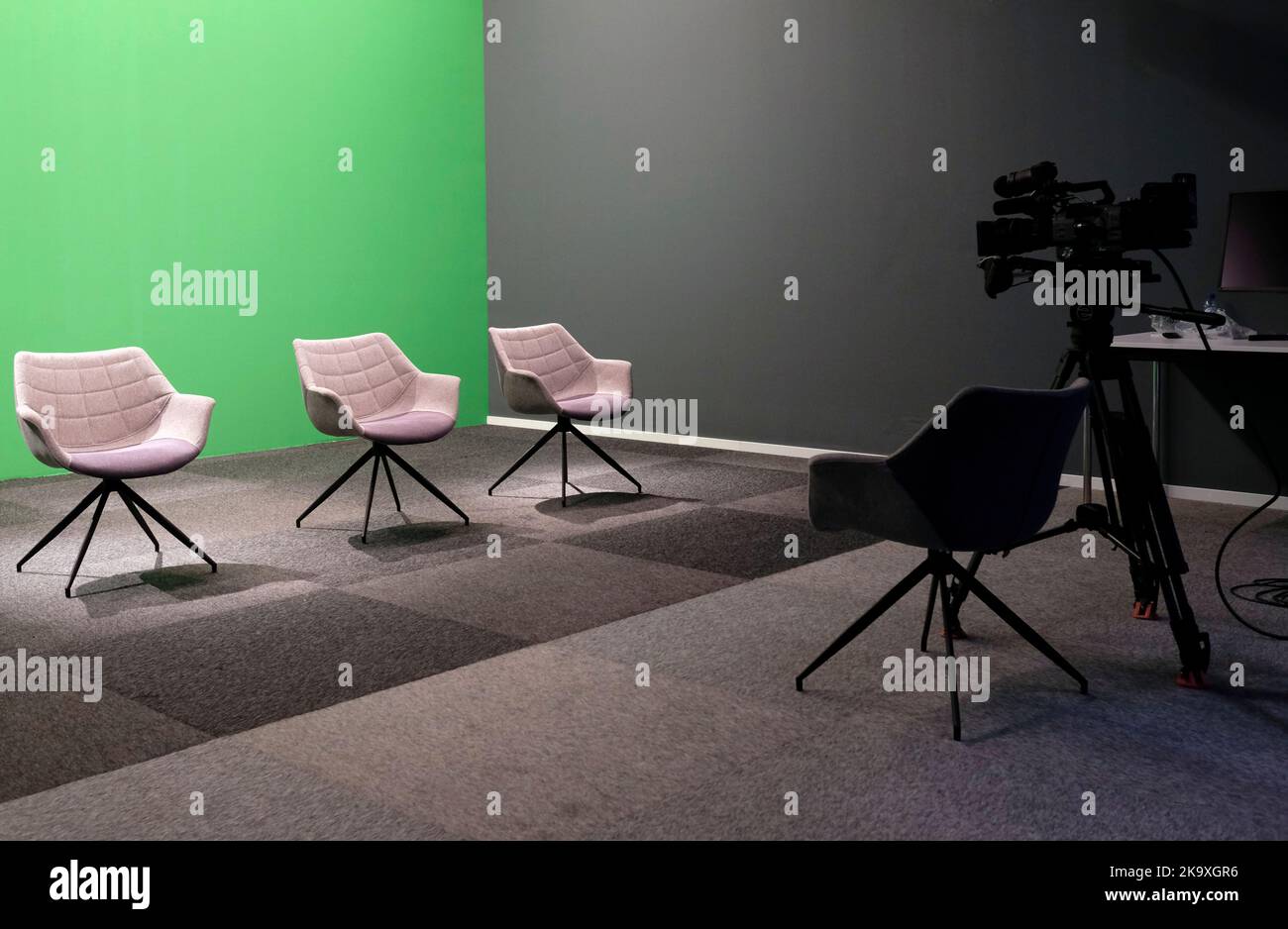 Three empty chairs in a TV studio with green screen Stock Photo - Alamy