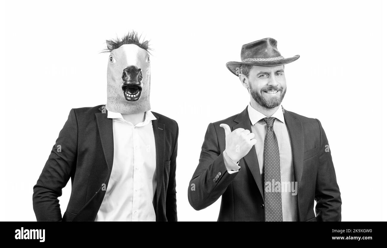 Happy man point finger at weird businessman wearing horse head mask in ...
