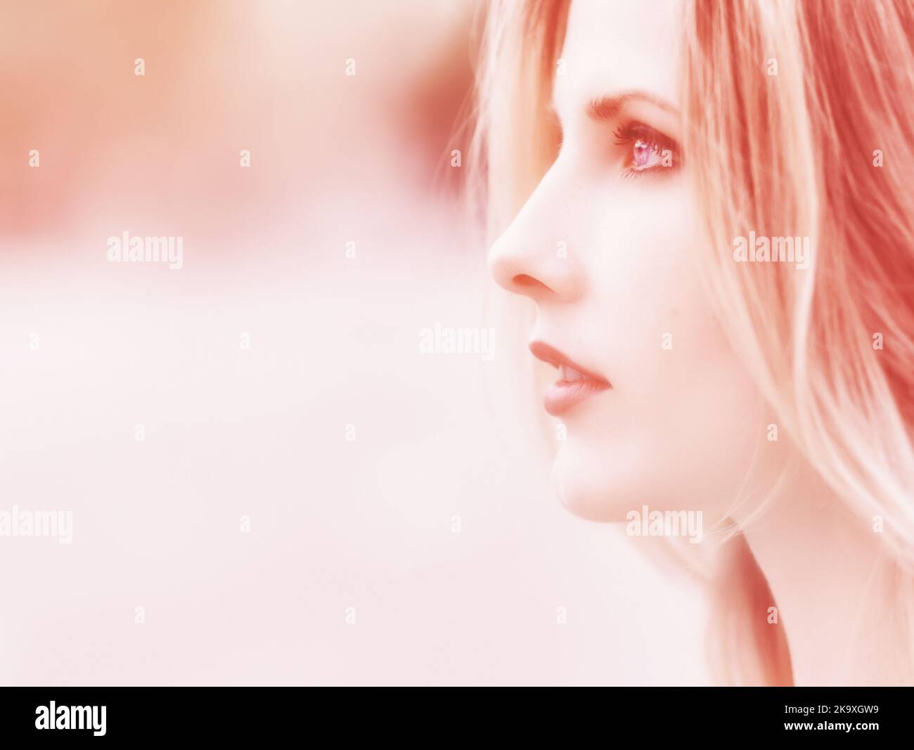 Girl in profile. Portrait of a beautiful woman. Toned in light pink ...