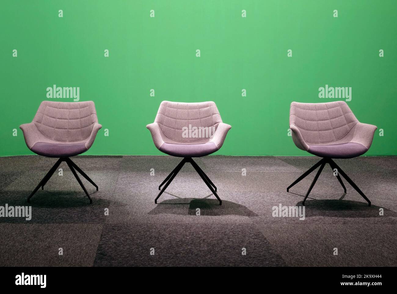 Three empty chairs in a TV studio with green screen Stock Photo - Alamy