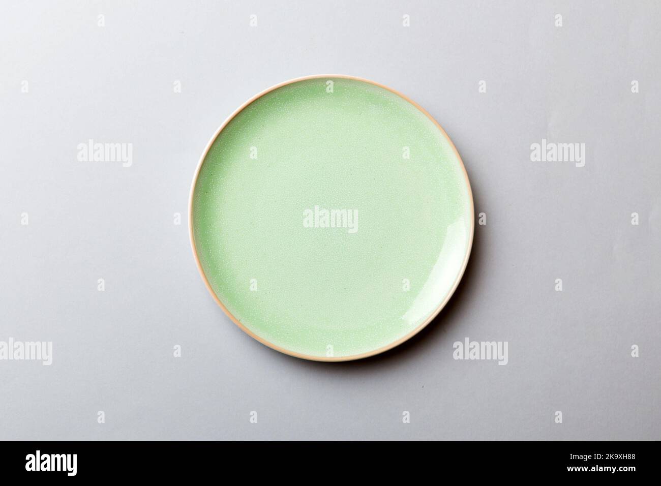 Top view of isolated of colored background empty round green plate for ...
