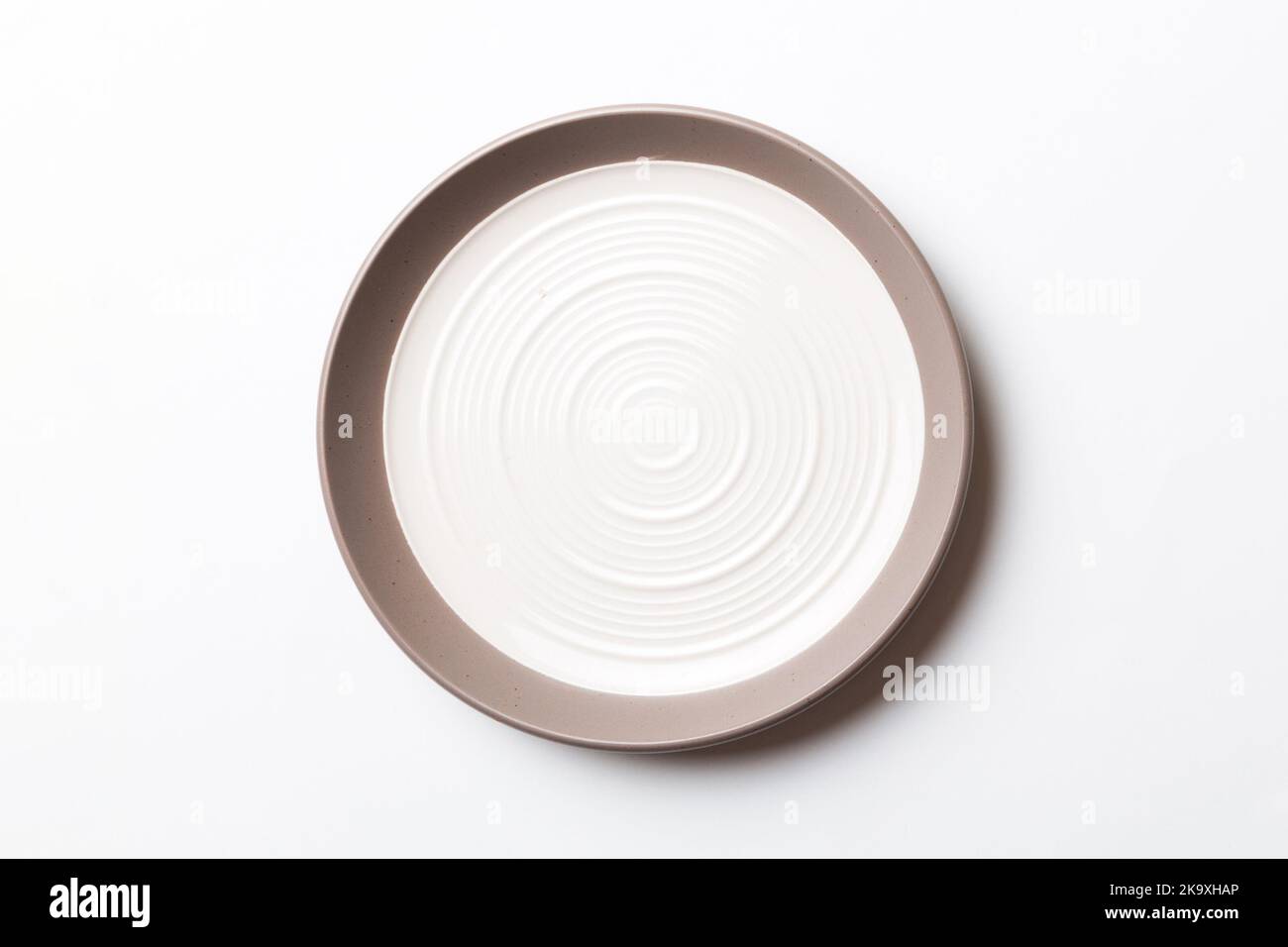 Top view of isolated of colored background empty round white plate for ...