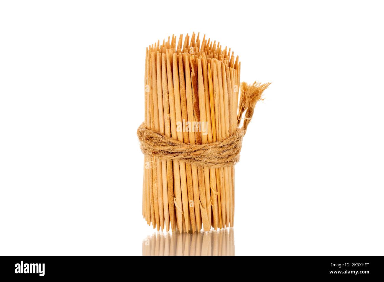 Wooden toothpicks tied with jute rope, macro, isolated on white ...