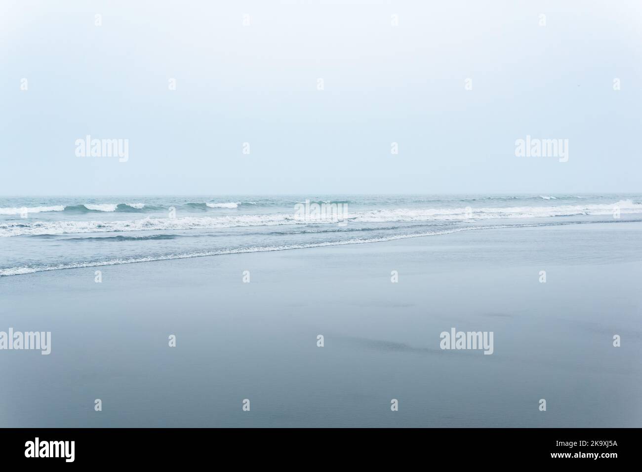 foggy seascape, cold ocean shore with a wide beach Stock Photo - Alamy