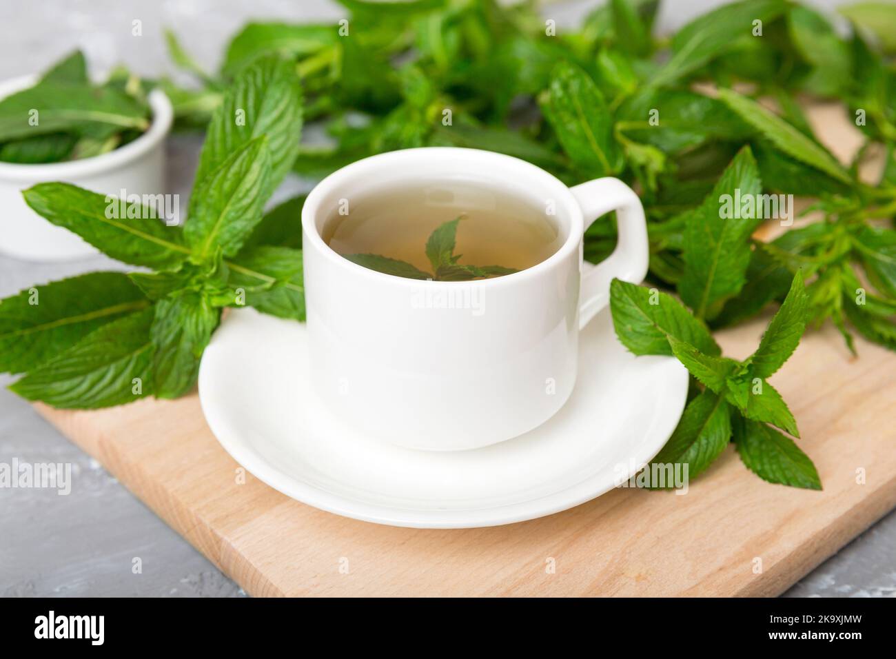 Cup of mint tea on table background. Green tea with fresh mint top view ...