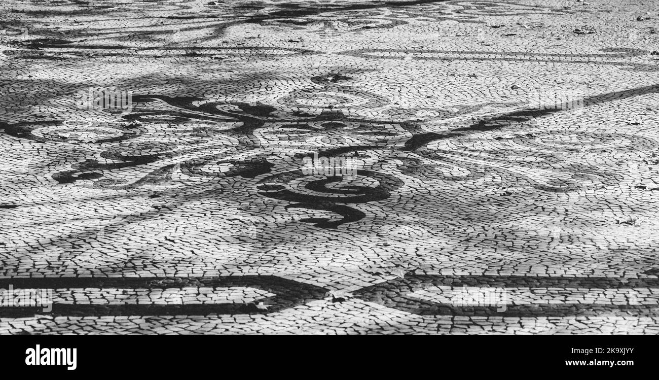 Traditional pavement in a stairs with black and white cobblestones ...