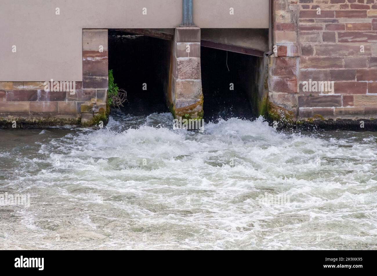 Outdoor scenery showing a wall with watergate and water Stock Photo - Alamy