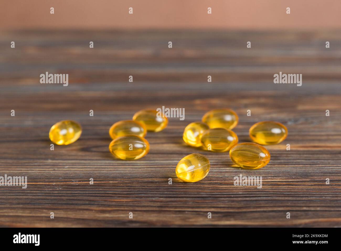 Cod liver oil omega 3 gel capsules on colored background with copy ...