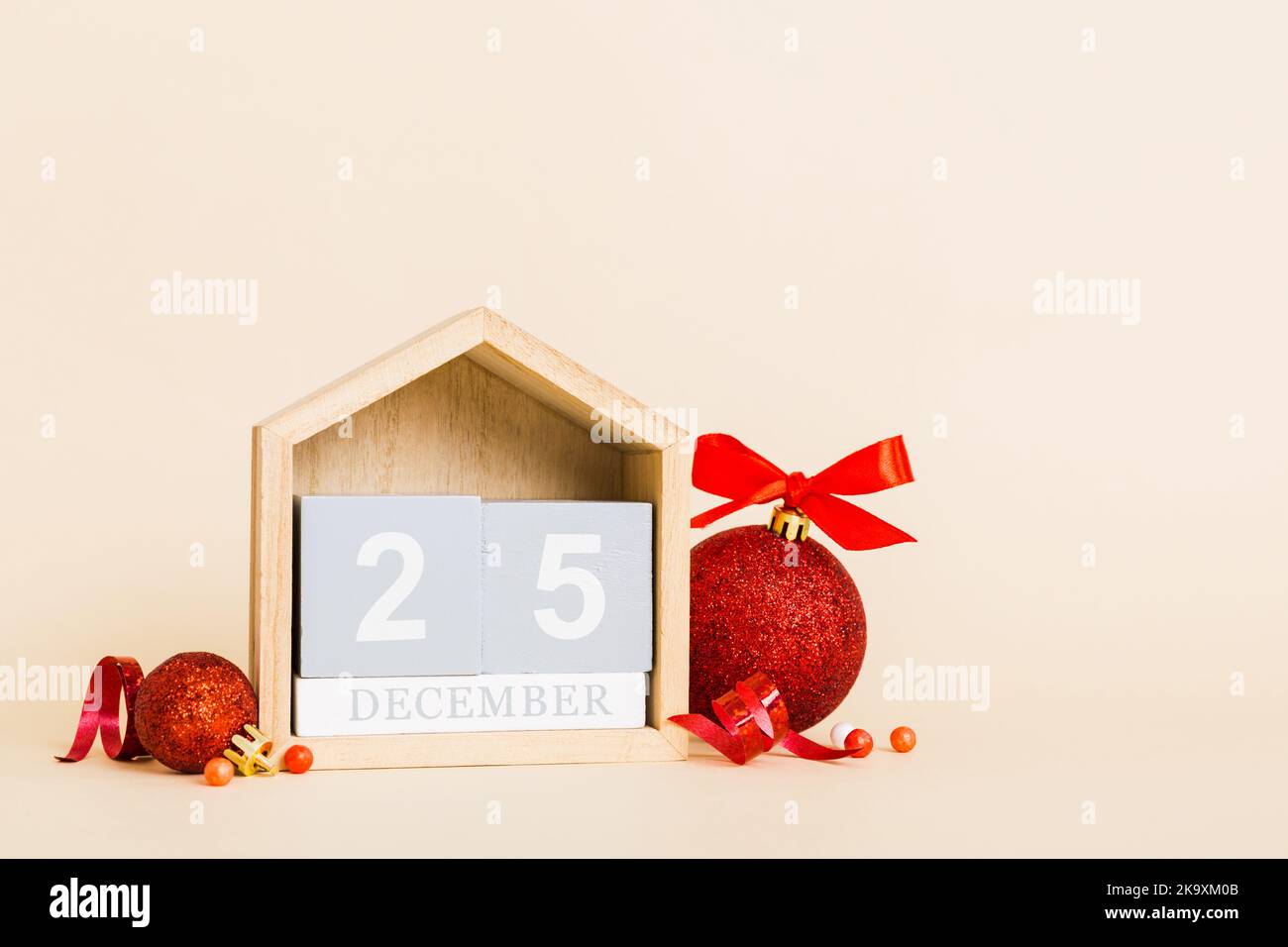 25 december. Christmas composition on colored background with a wooden ...