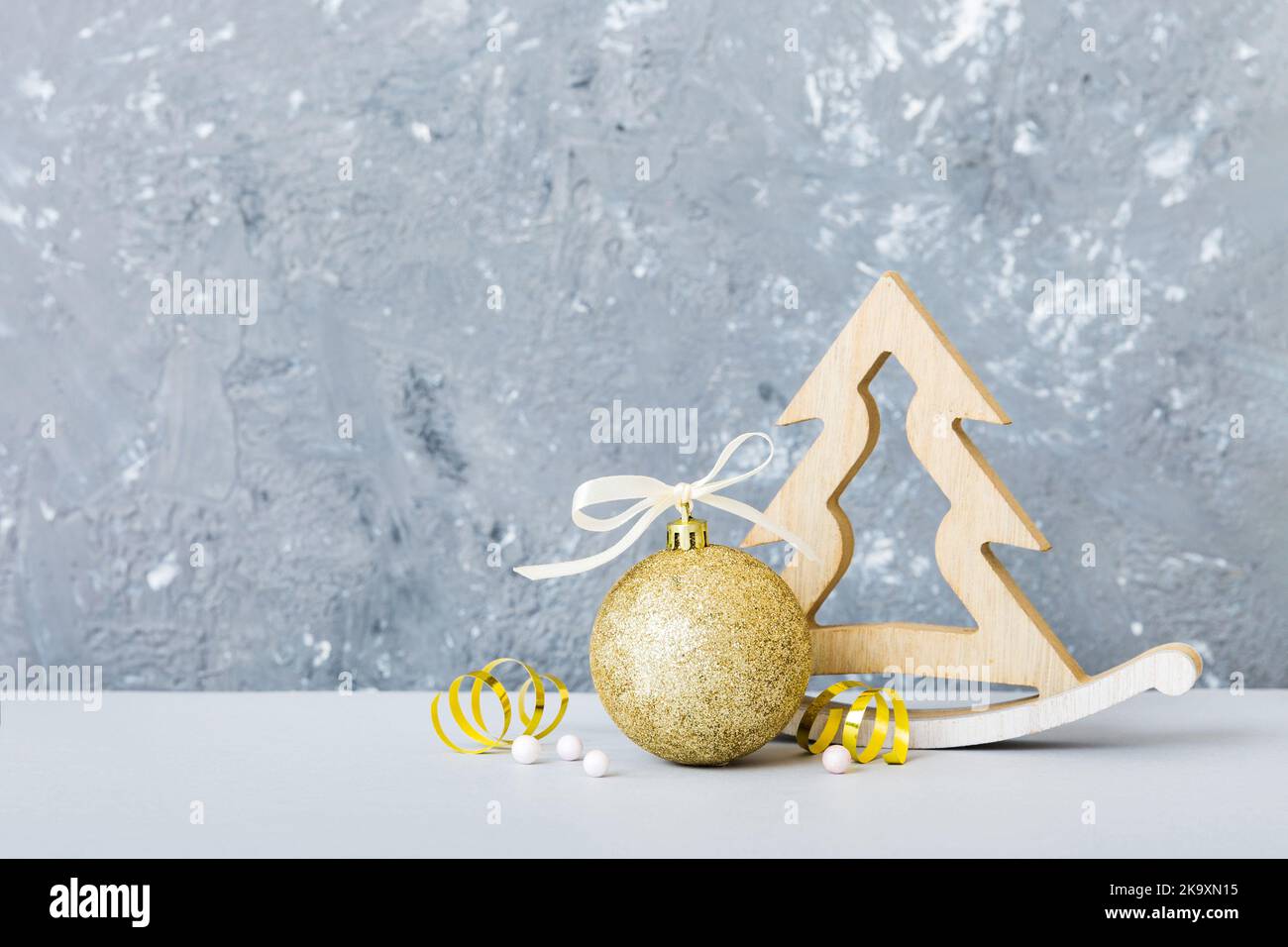 Christmas ball with decorative wooden tree on colored background ...