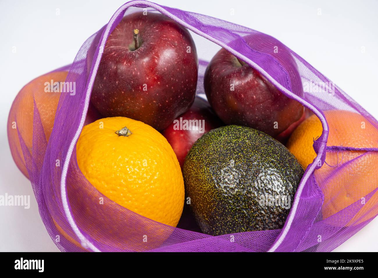 Fabric mesh for fruits and vegetables on a white background. A reusable ...