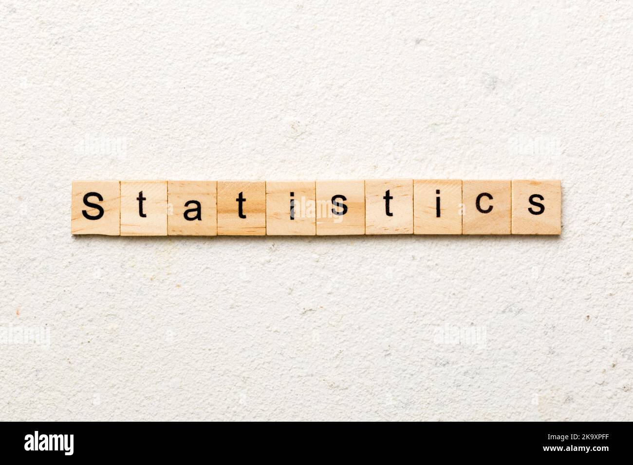 statistics word written on wood block. statistics text on cement table ...