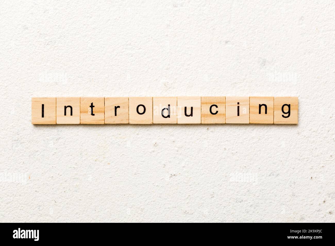 introducing word written on wood block. introducing text on table ...
