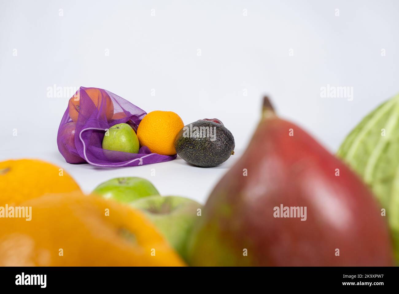 Fabric mesh for fruits and vegetables on a white background. A reusable ...