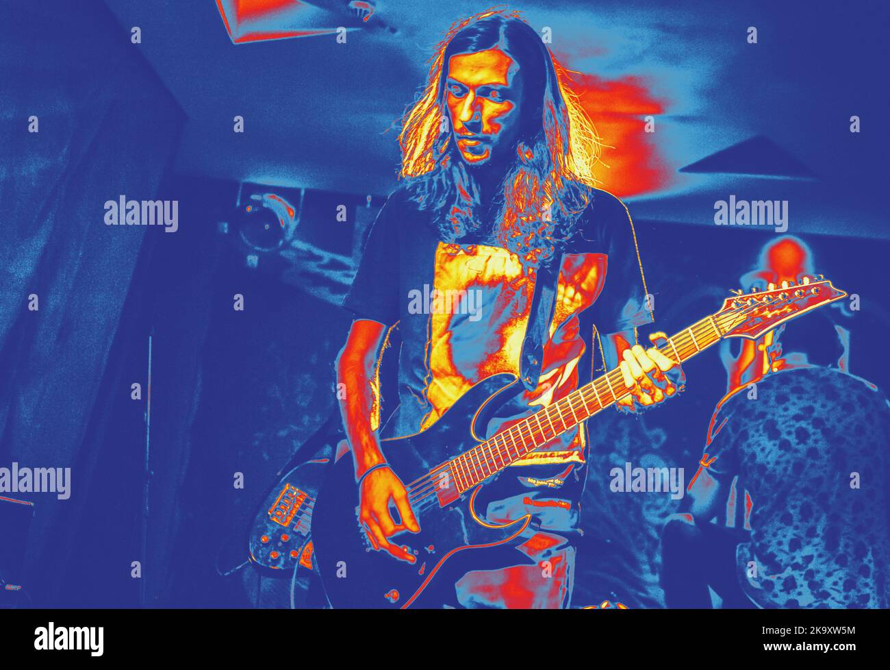 Rock musician on stage retro style rock music man with long hair ...