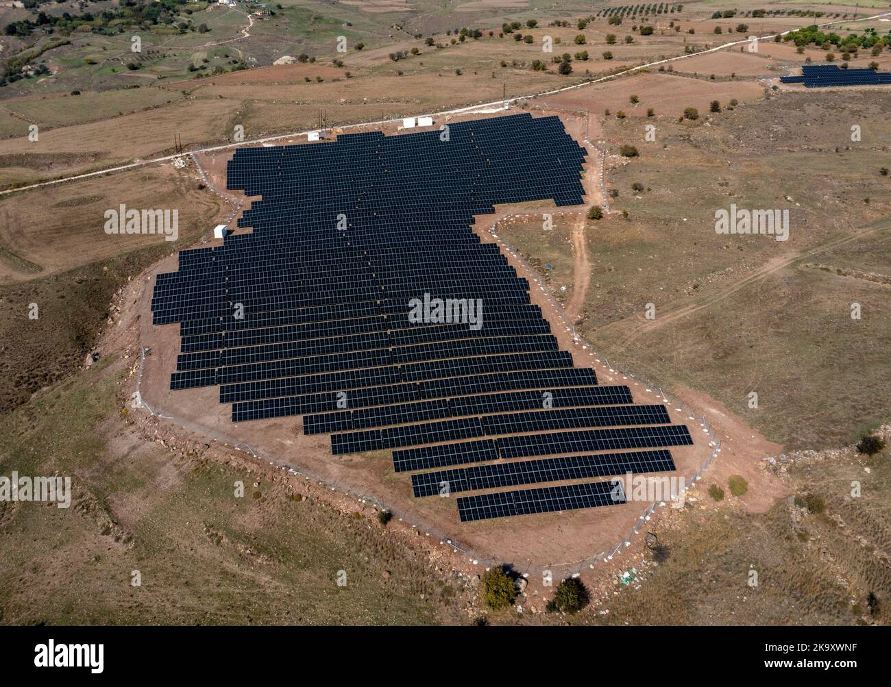 Aerial view of solar panels on a hillside near Thrinia, Paphos district ...