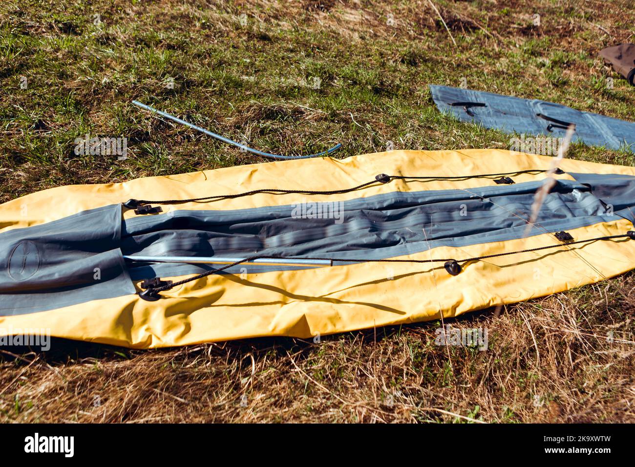 Deflated rubber boat and a pump on the grass Stock Photo - Alamy