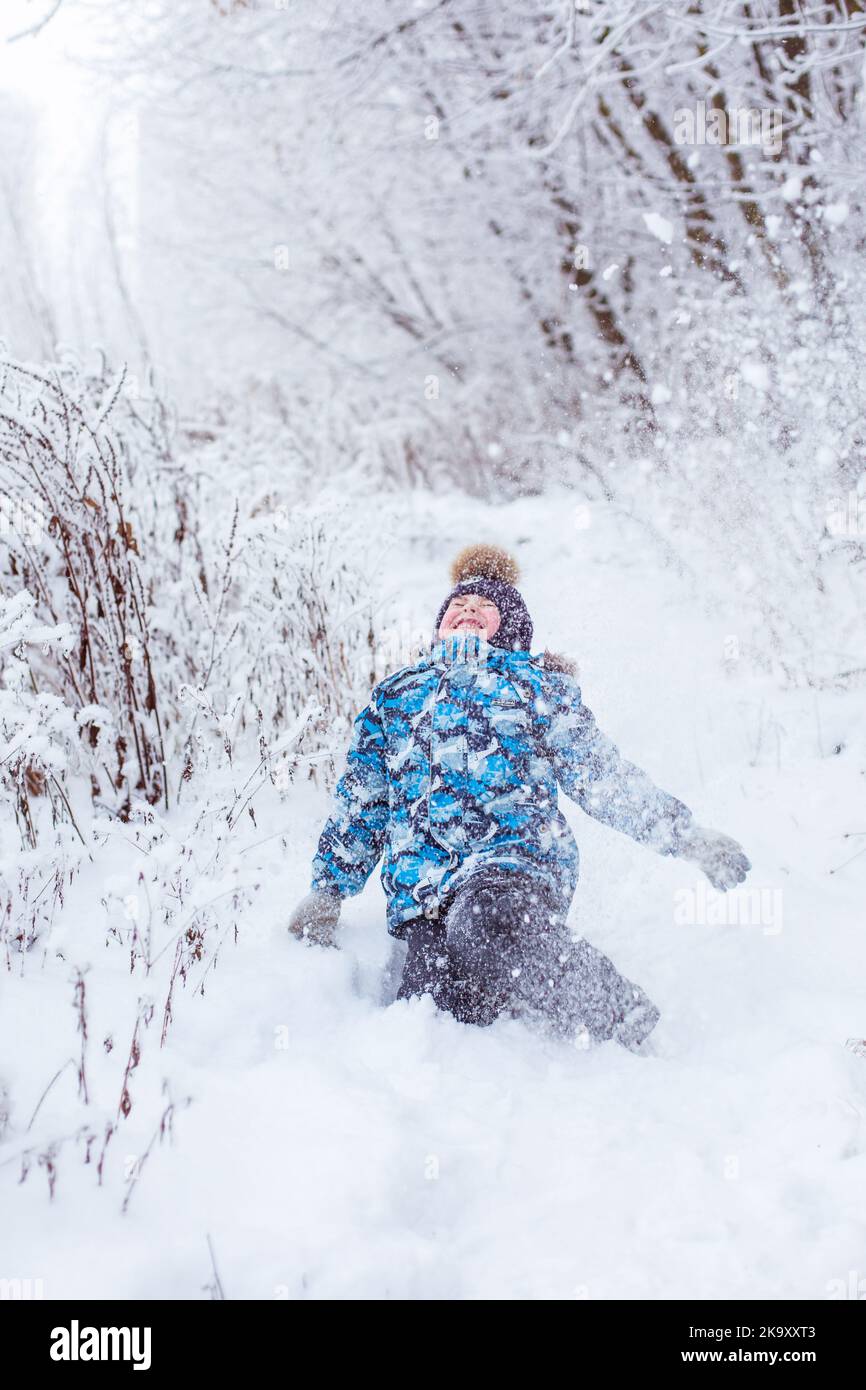 boy throwing snow in the air at sunny winter day, back view Stock Photo ...