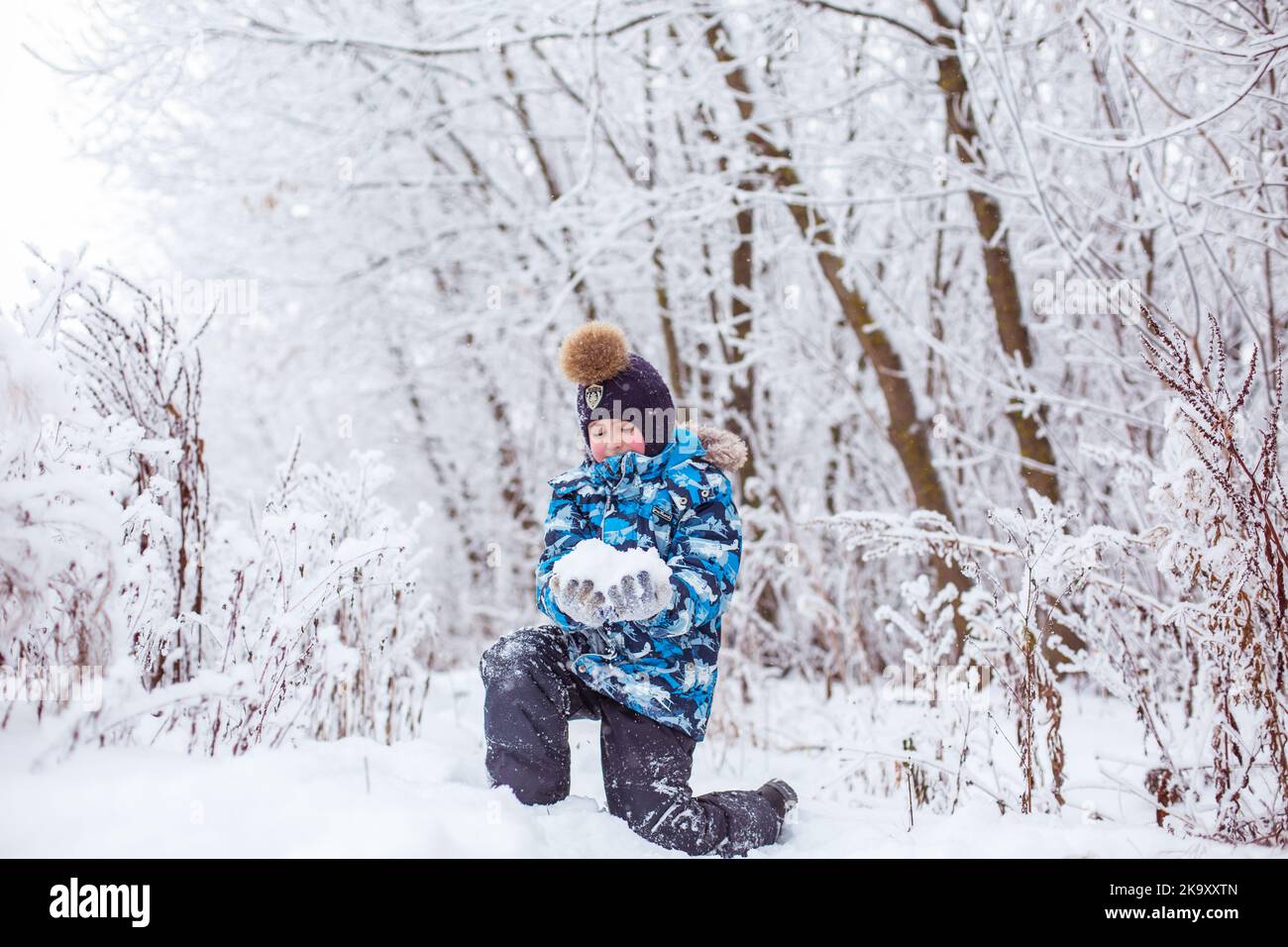 boy throwing snow in the air at sunny winter day, back view Stock Photo ...