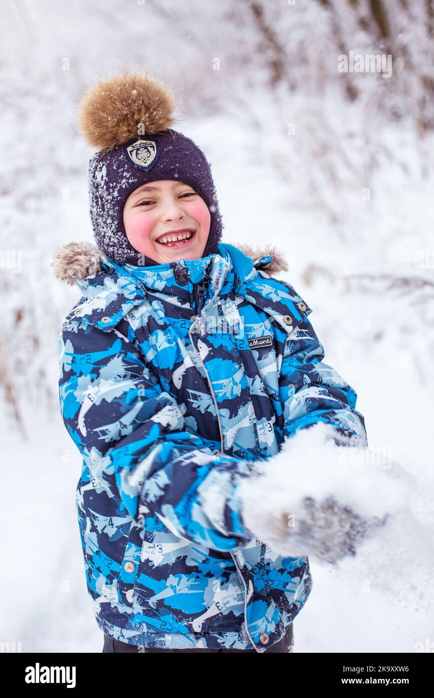 boy throwing snow in the air at sunny winter day, back view Stock Photo ...