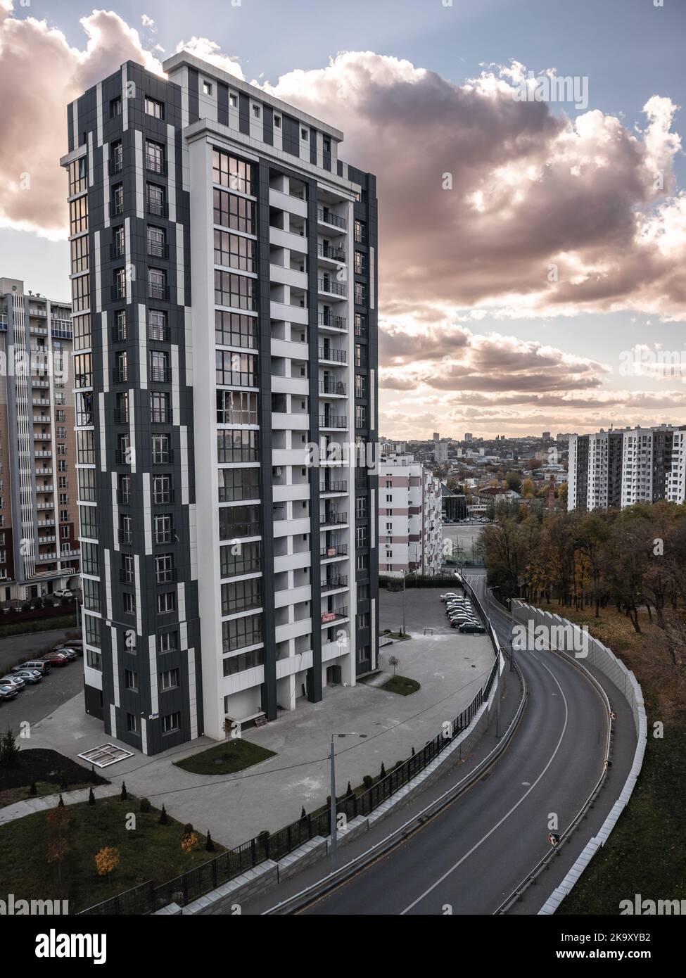 Modern residential buildings and uphill street in epic sunset light ...