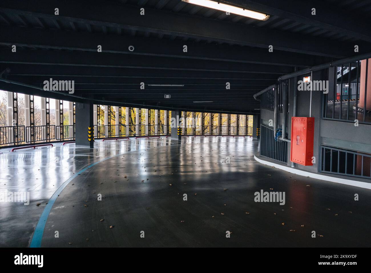 Drive down inside empty circle multilevel parking with view on golden ...