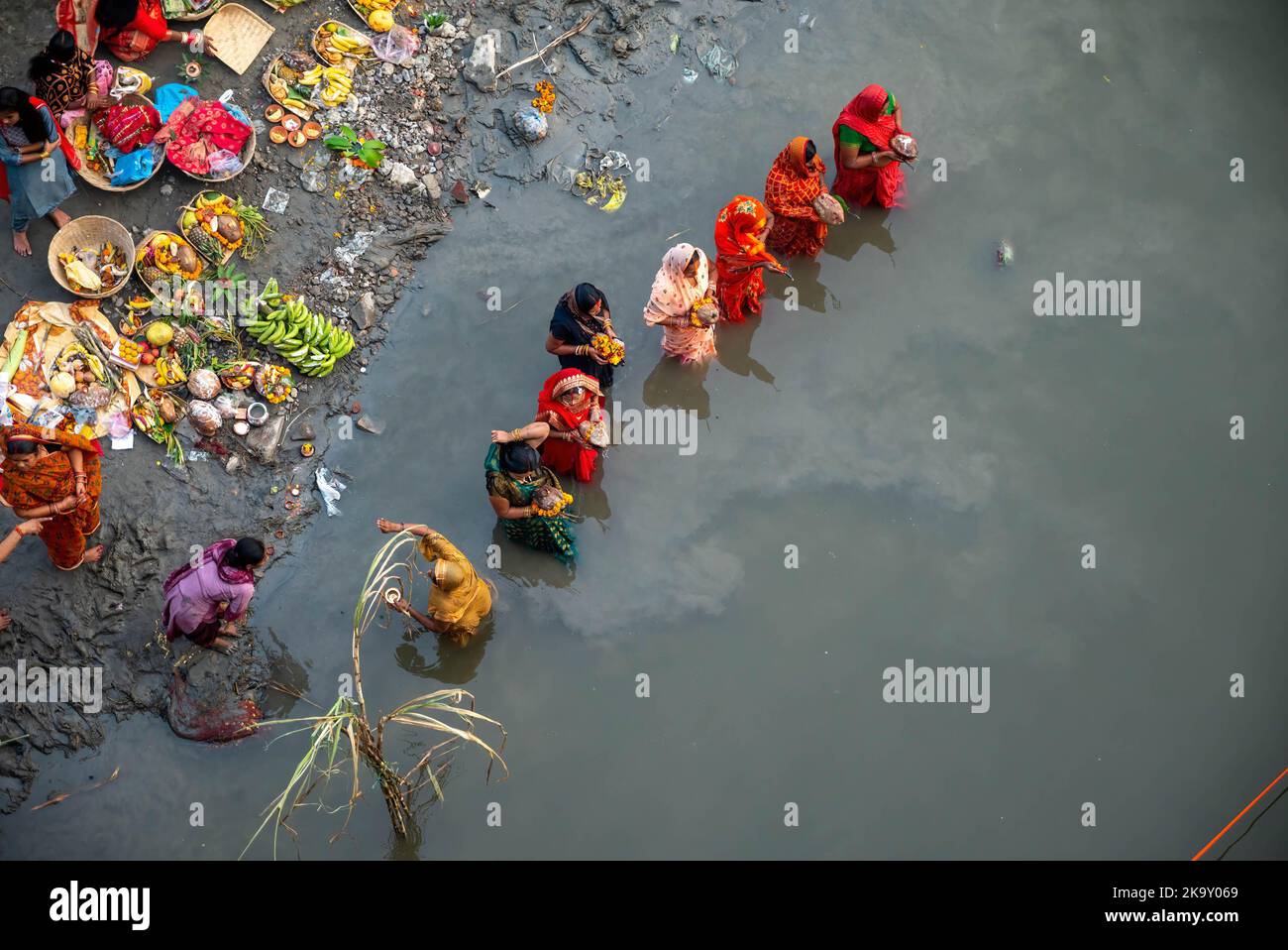 A top view of devotees standing in Yamuna river and offering prayers to ...