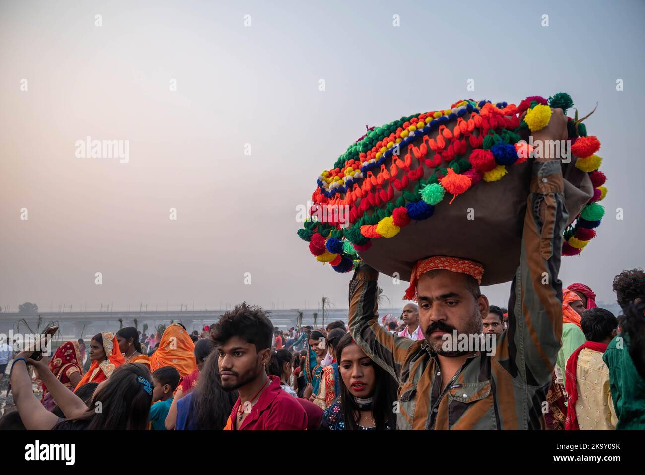 Noida, India. 30th Oct, 2022. A devotee carries a colorful basket full ...