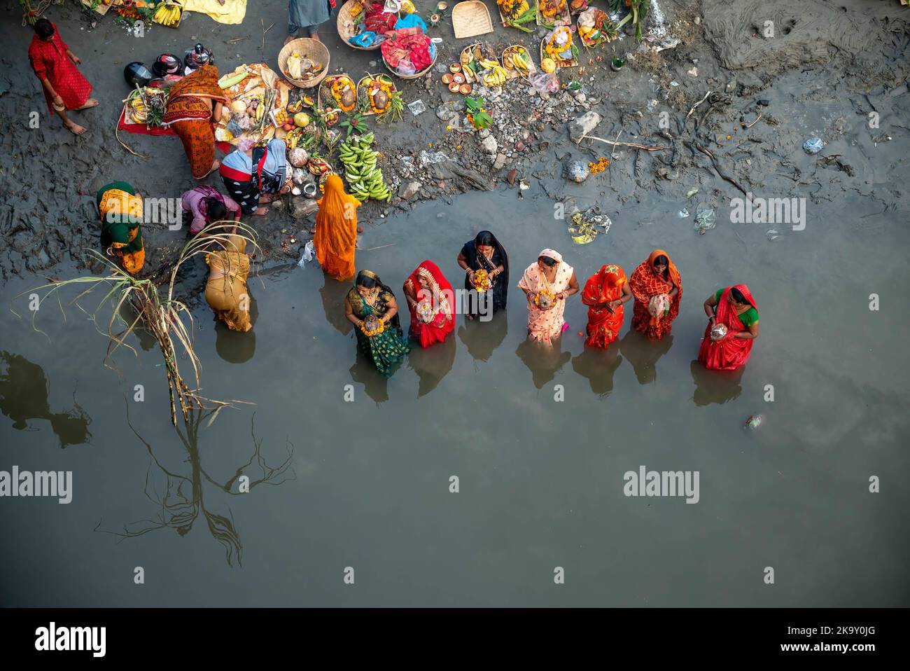 A top view of devotees standing in Yamuna river and offering prayers to ...