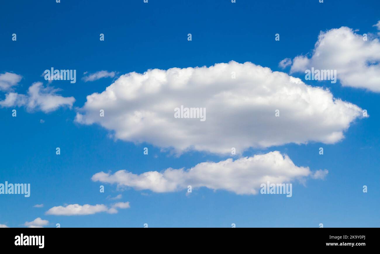 Summer sky. Cumulus clouds on a blue background. Partly cloudy. Dark ...