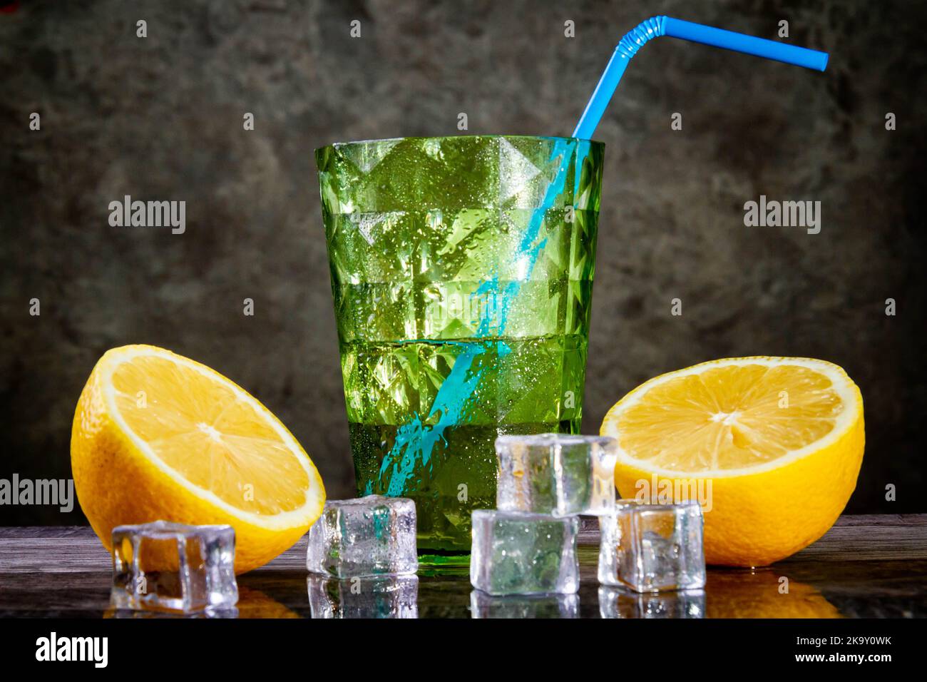 A glass of ice-cold lemon juice. Fruit juice with ice. Lemon slices and ice. Copyspace Stock ...