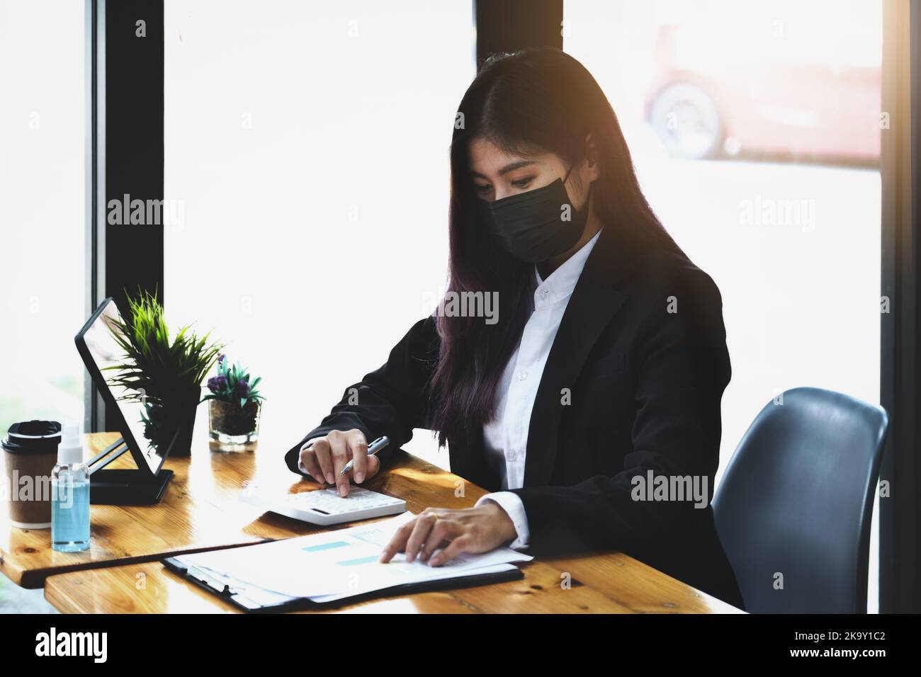 Business woman using calculator to review balance sheet annual using ...