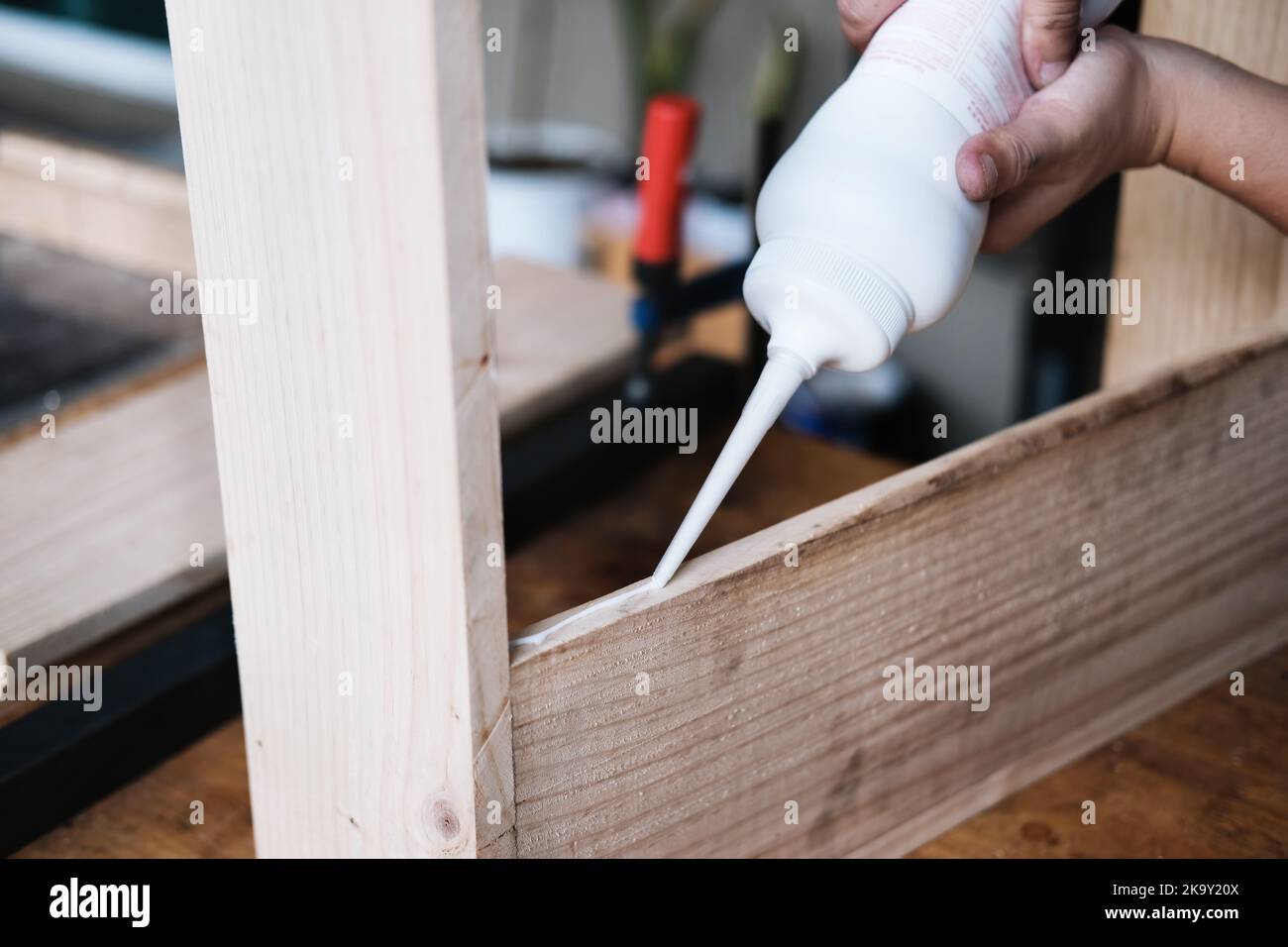 Woodworking operators are using glue to put together the wood parts to ...