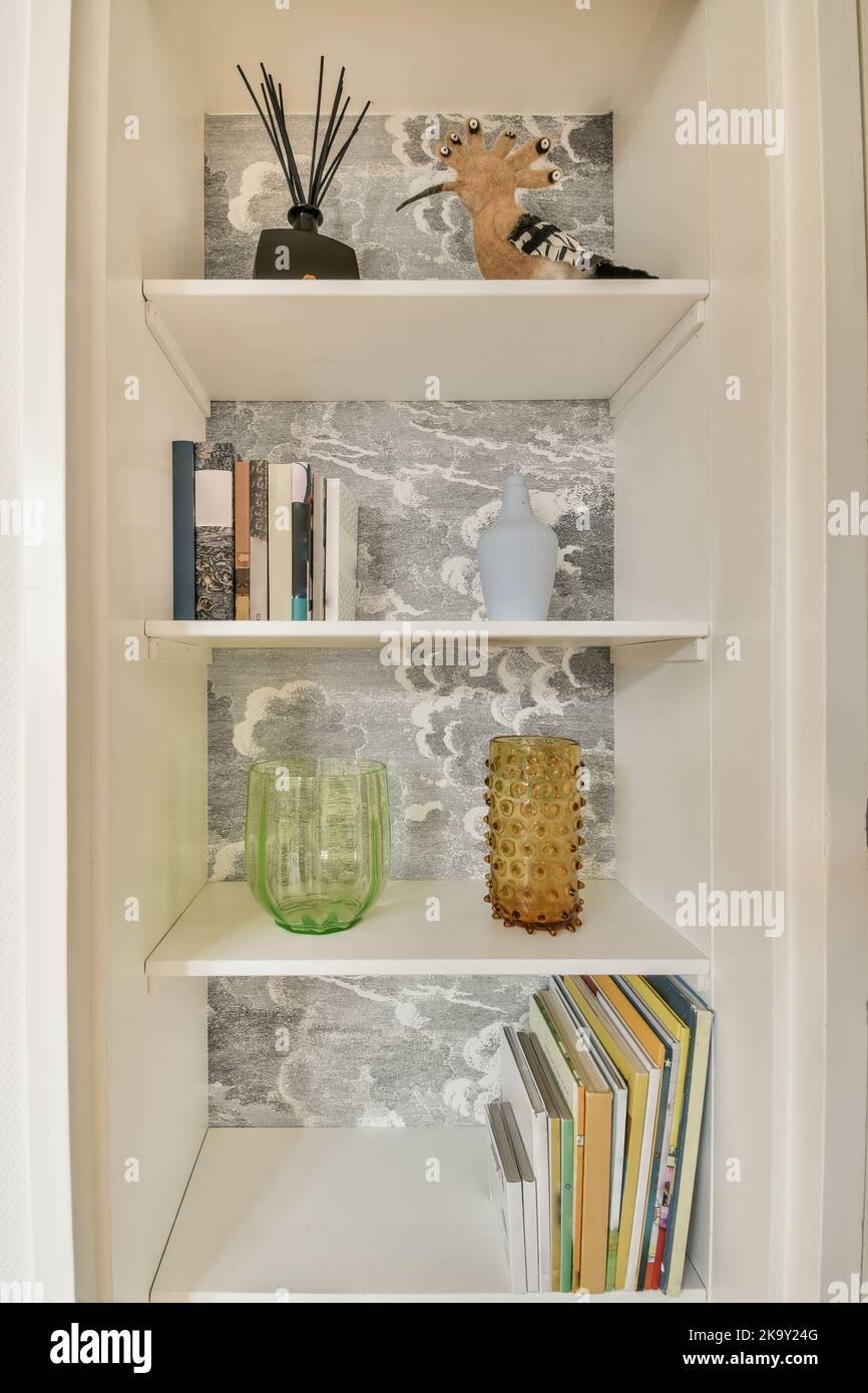 Modern cupboard in spacious room with white walls Stock Photo - Alamy