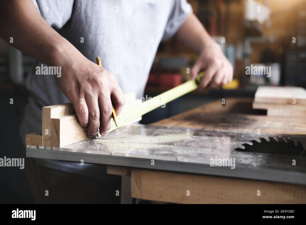 do-it-yourself concept Craftsmen use a tape measure to assemble wooden ...