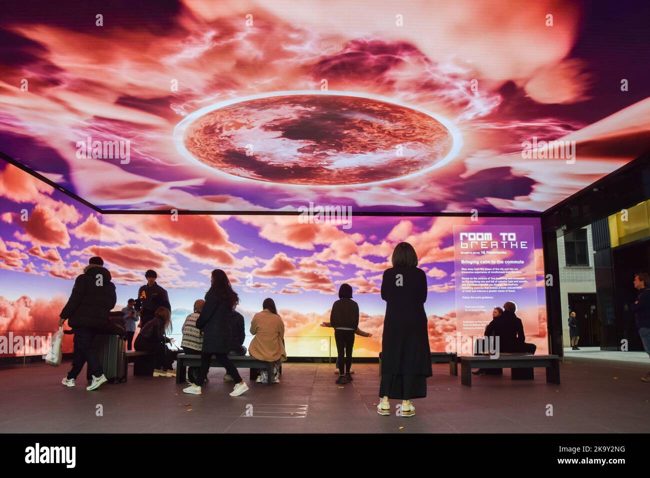 London, UK. 30th October 2022. People admire the digital art on screens ...