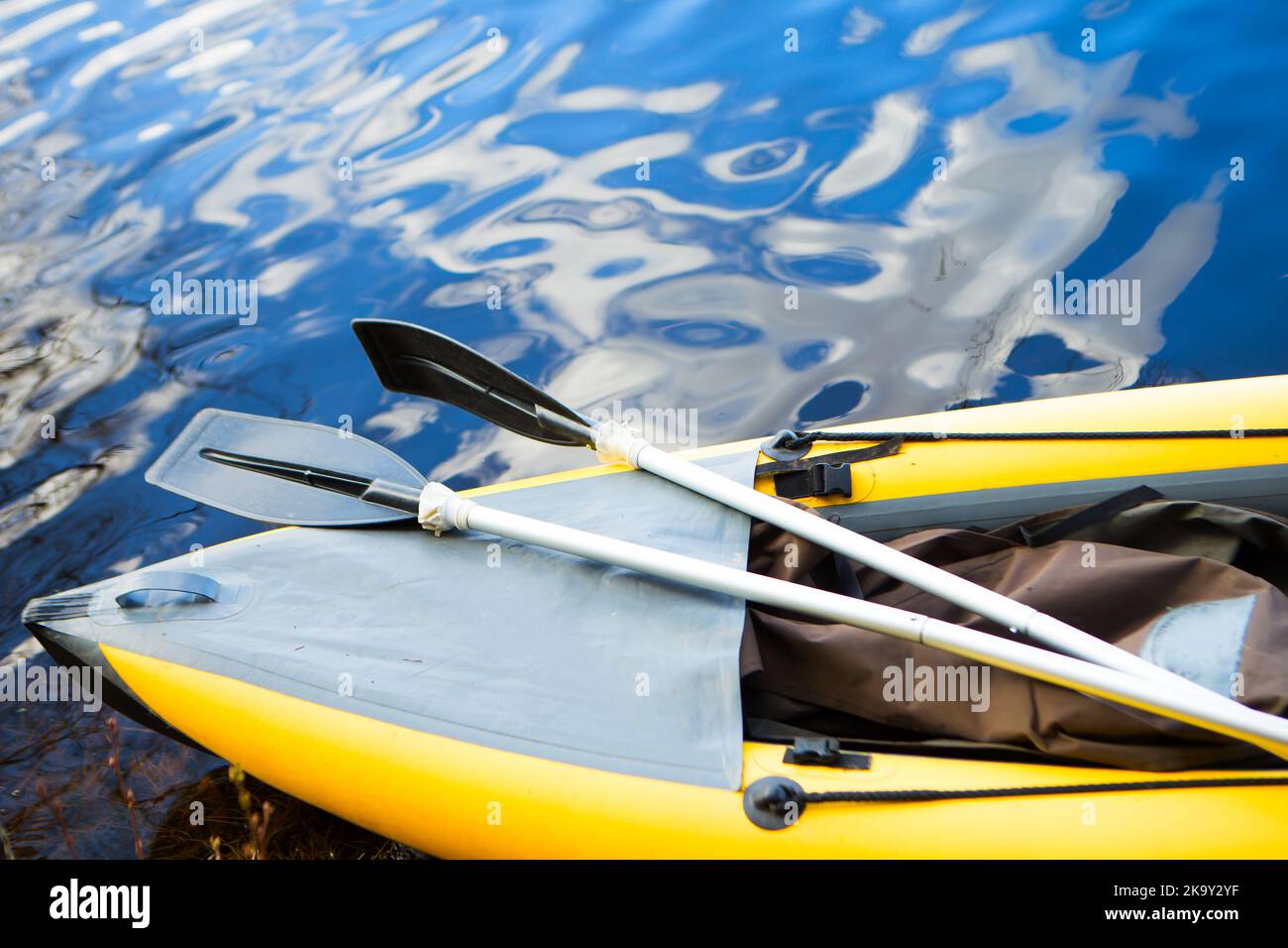 yellow inflatable boat with oars on the water Stock Photo - Alamy