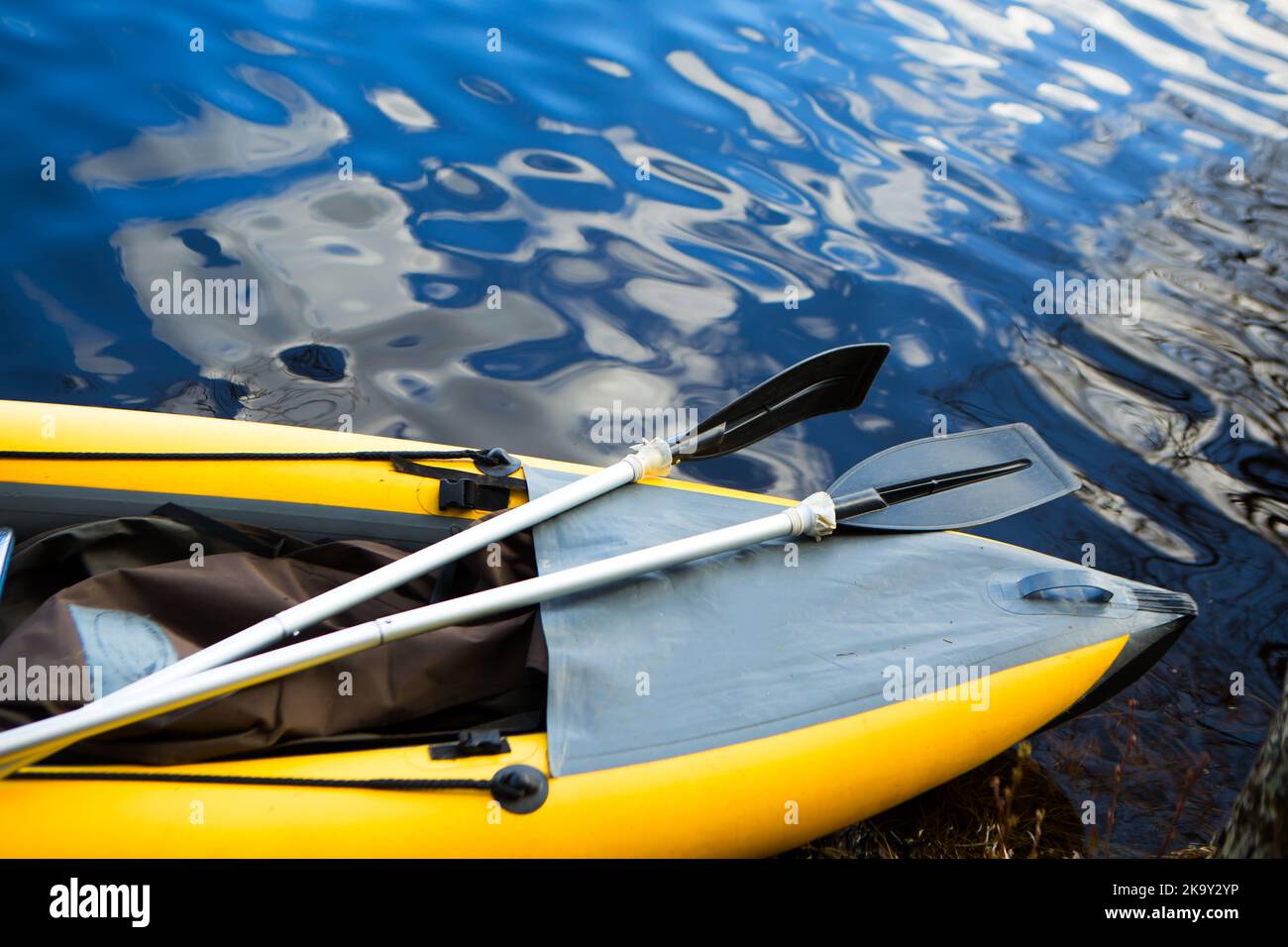 yellow inflatable boat with oars on the water Stock Photo - Alamy