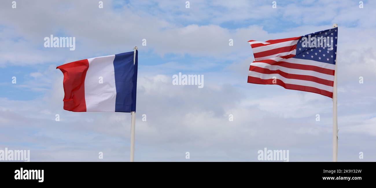 two large American and French flags waving together as a sign of ...